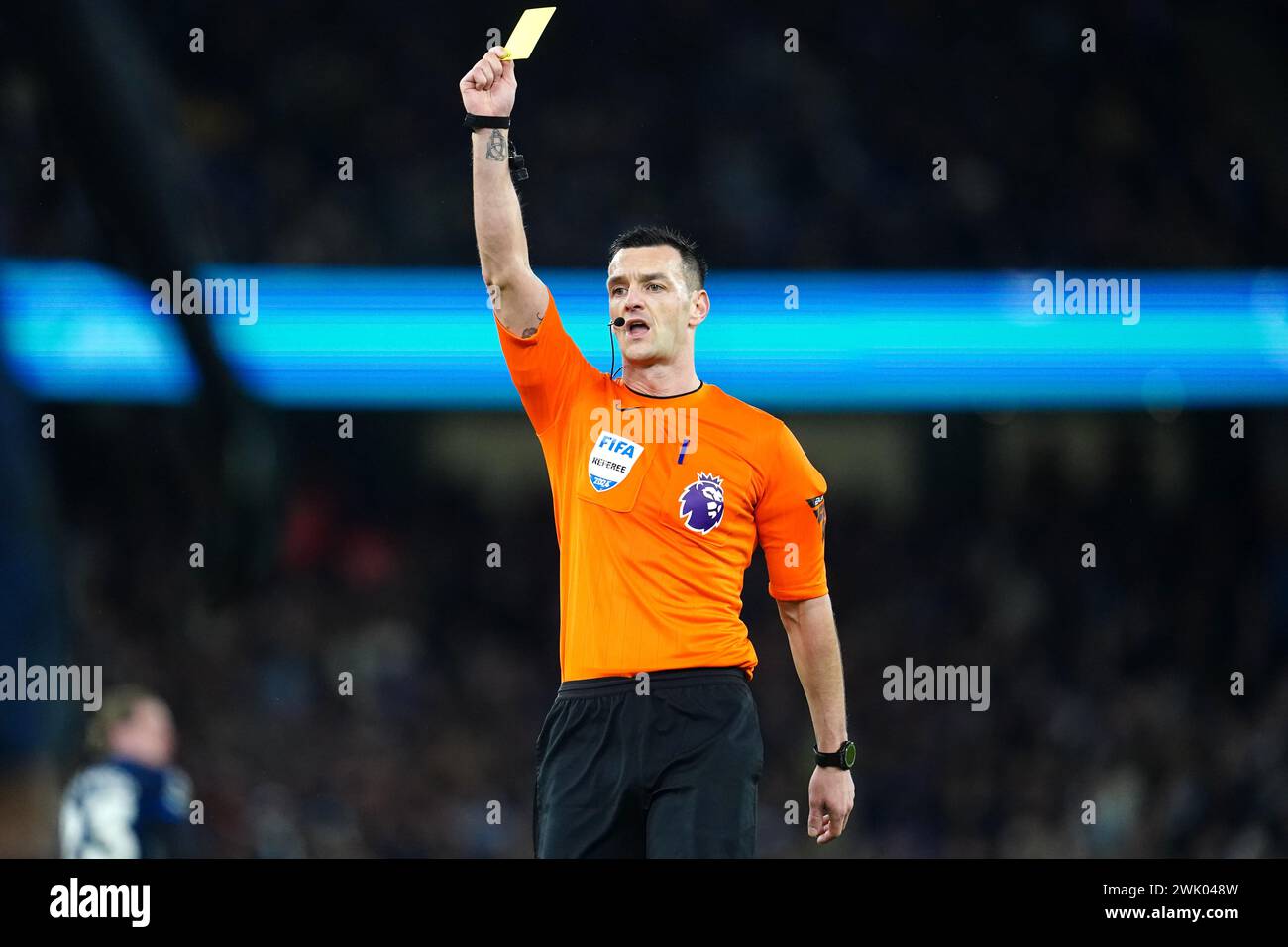 Referee Andrew Madley shows a yellow card to Chelsea goalkeeper Djordje ...