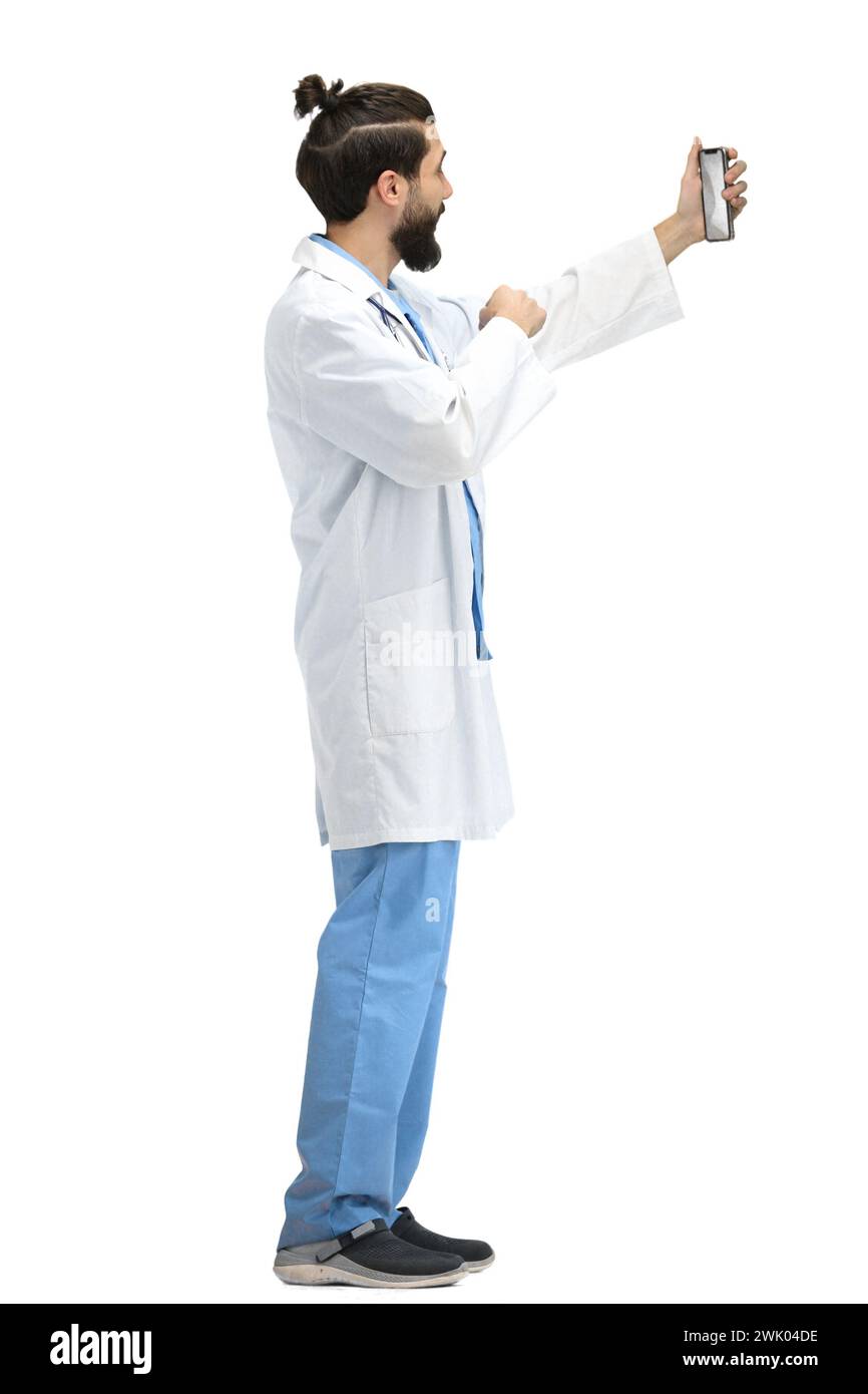 Male doctor, full-length, on a white background, with a phone Stock ...