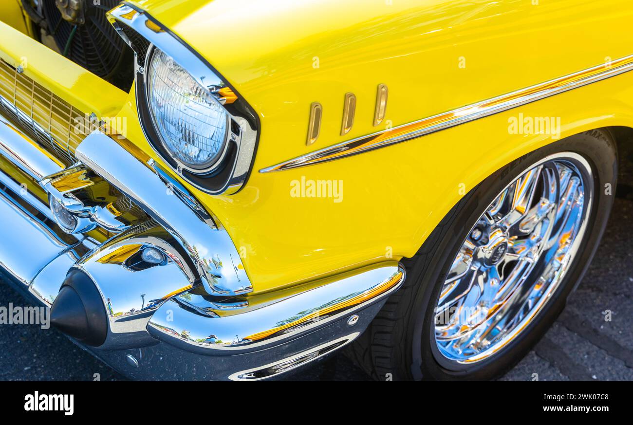 Close-up of the headlight from a restored vintage classic custom yellow ...