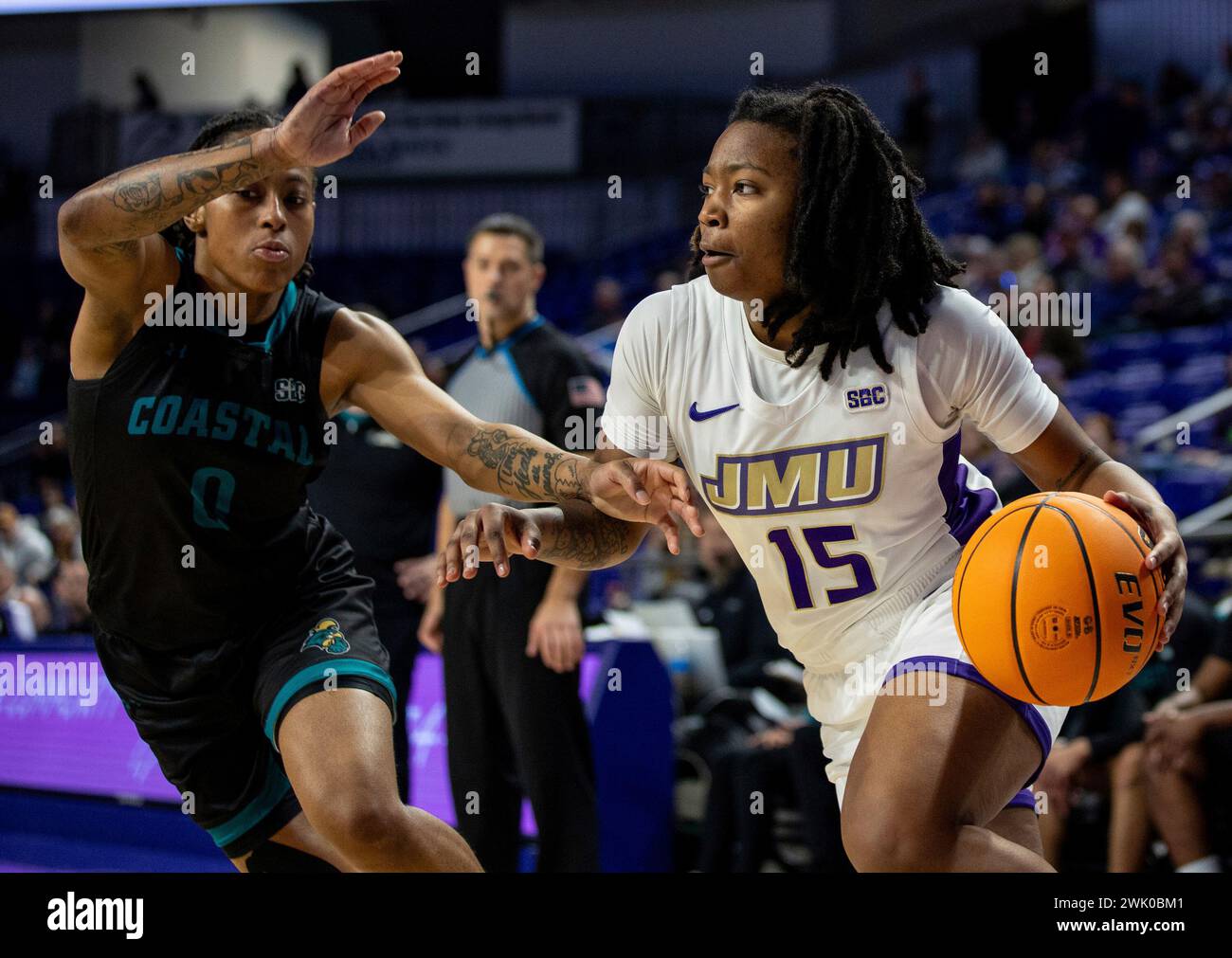 James Madison guard Jada Mills (15) drives around Coastal Carolina ...