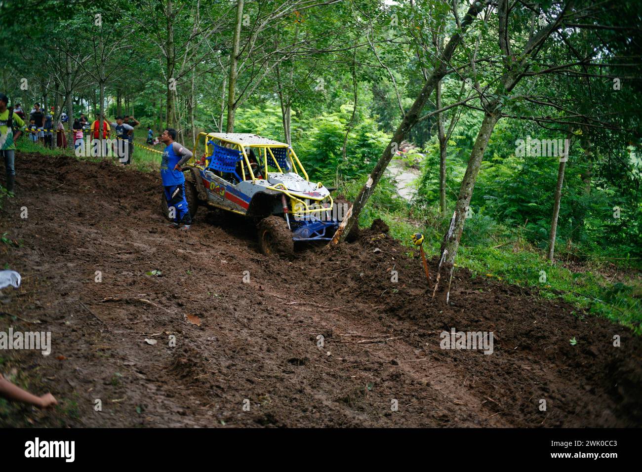 An off-road car had an accident hitting a tree on a muddy track during ...