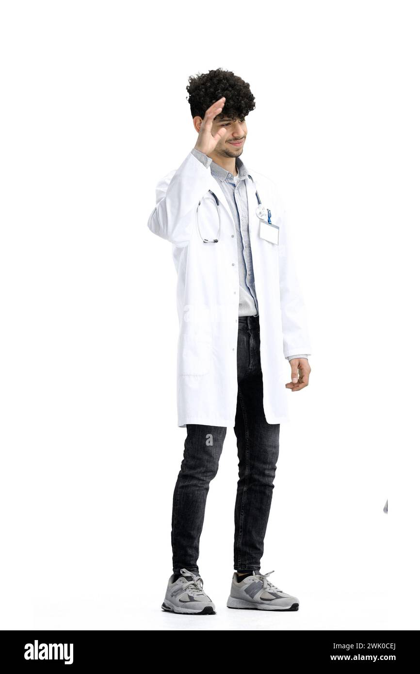 A male doctor, full-length, on a white background, waving his hand ...