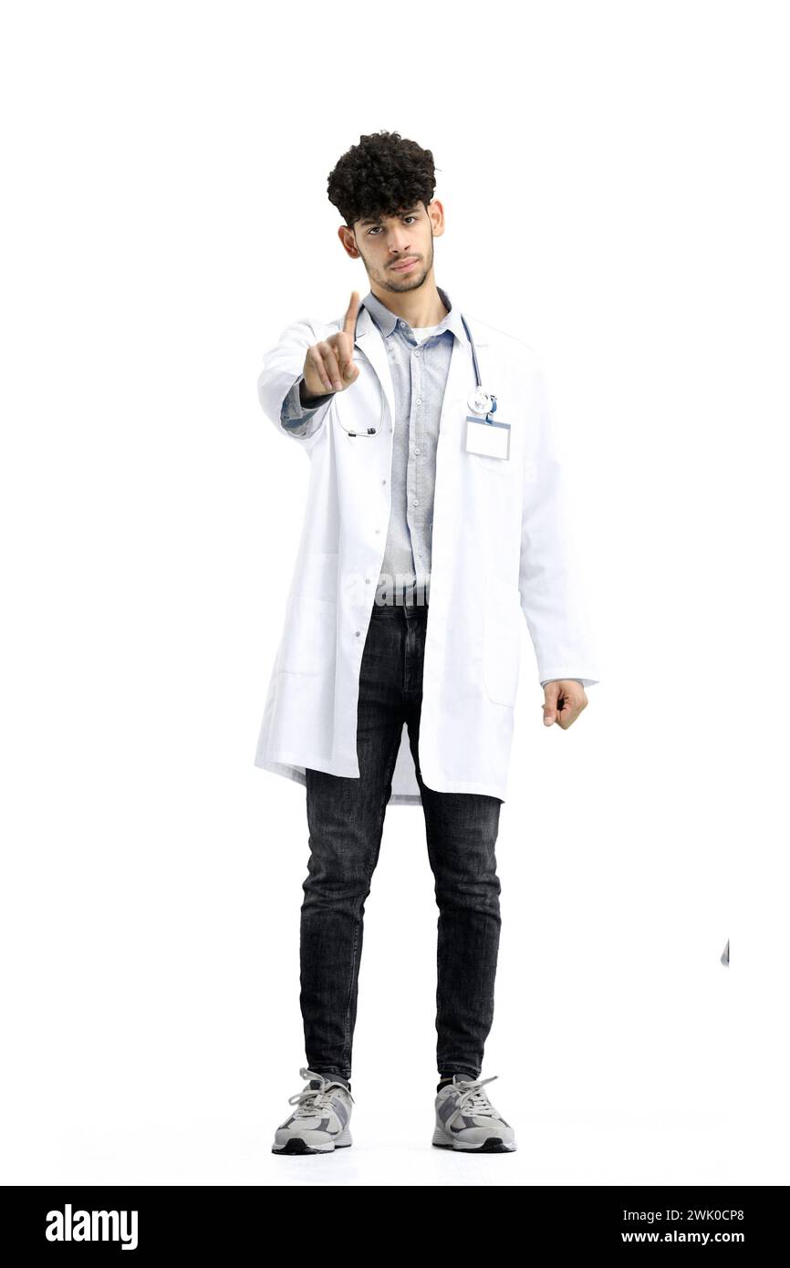 Male doctor, full-length, on a white background, shows a stop sign ...