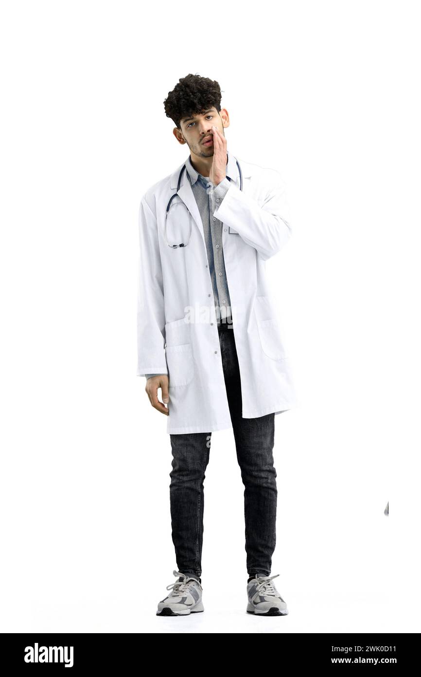 A male doctor, full-length, on a white background, tells a secret Stock ...