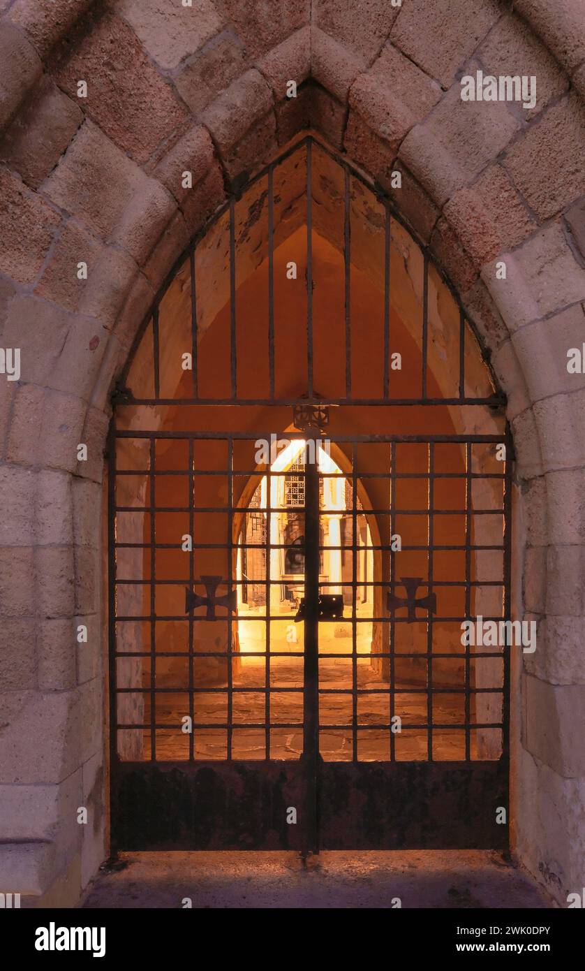 Gate with iron bars in a medieval fortress wall in the early morning ...