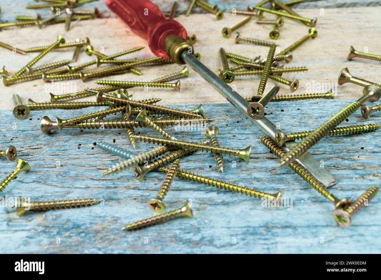 Screwdriver and brass wood screws around it. Reclaimed wood table Stock ...