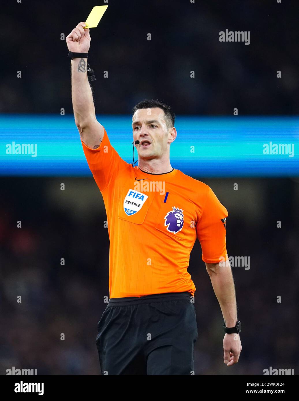 Referee Andrew Madley shows a yellow card to Chelsea goalkeeper Djordje ...