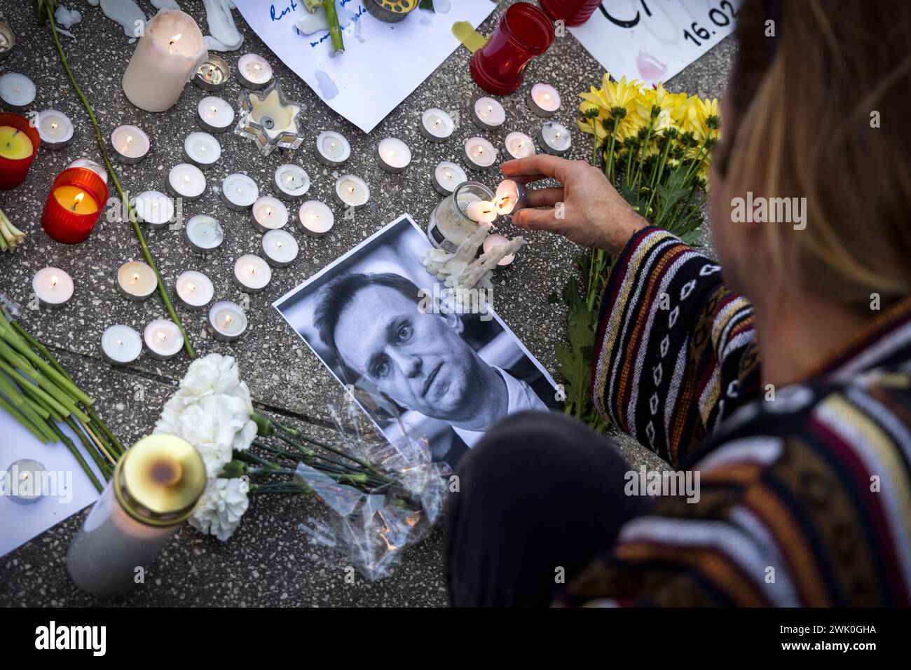 Lisbon, Portugal. 17th Feb, 2024. A mourner is seen lighting candles ...
