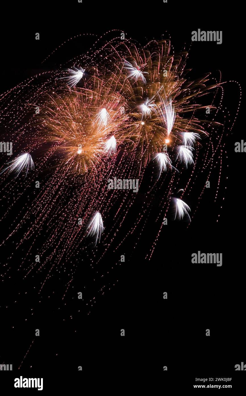 Red, white and gold fireworks bursts in night sky Stock Photo - Alamy