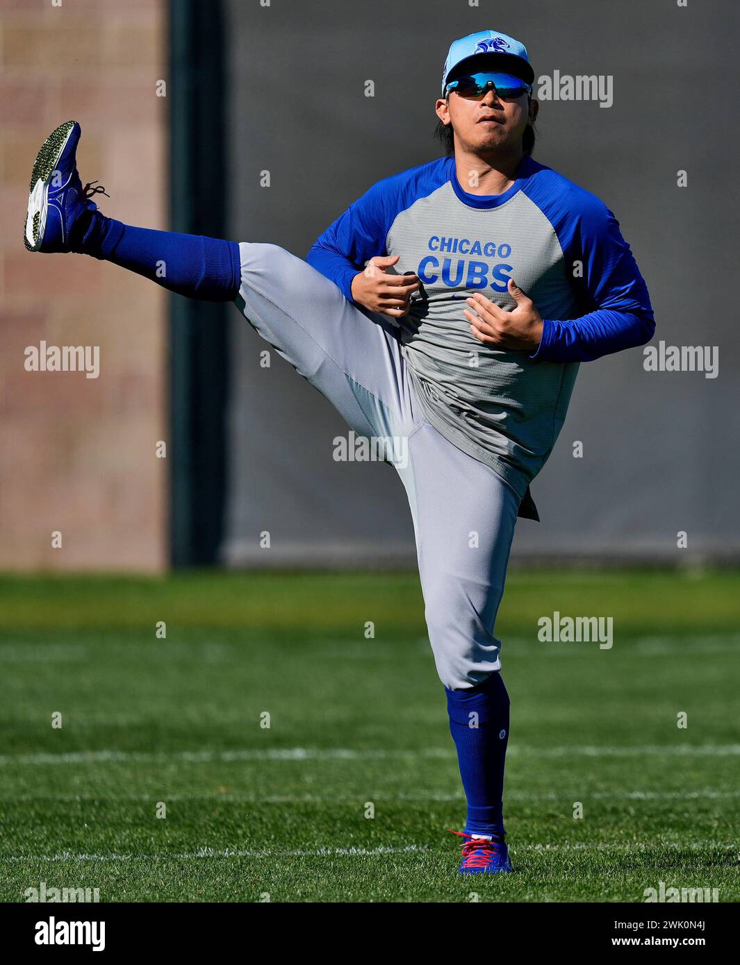 Chicago Cubs pitcher Shota Imanaga stretches during a baseball spring ...