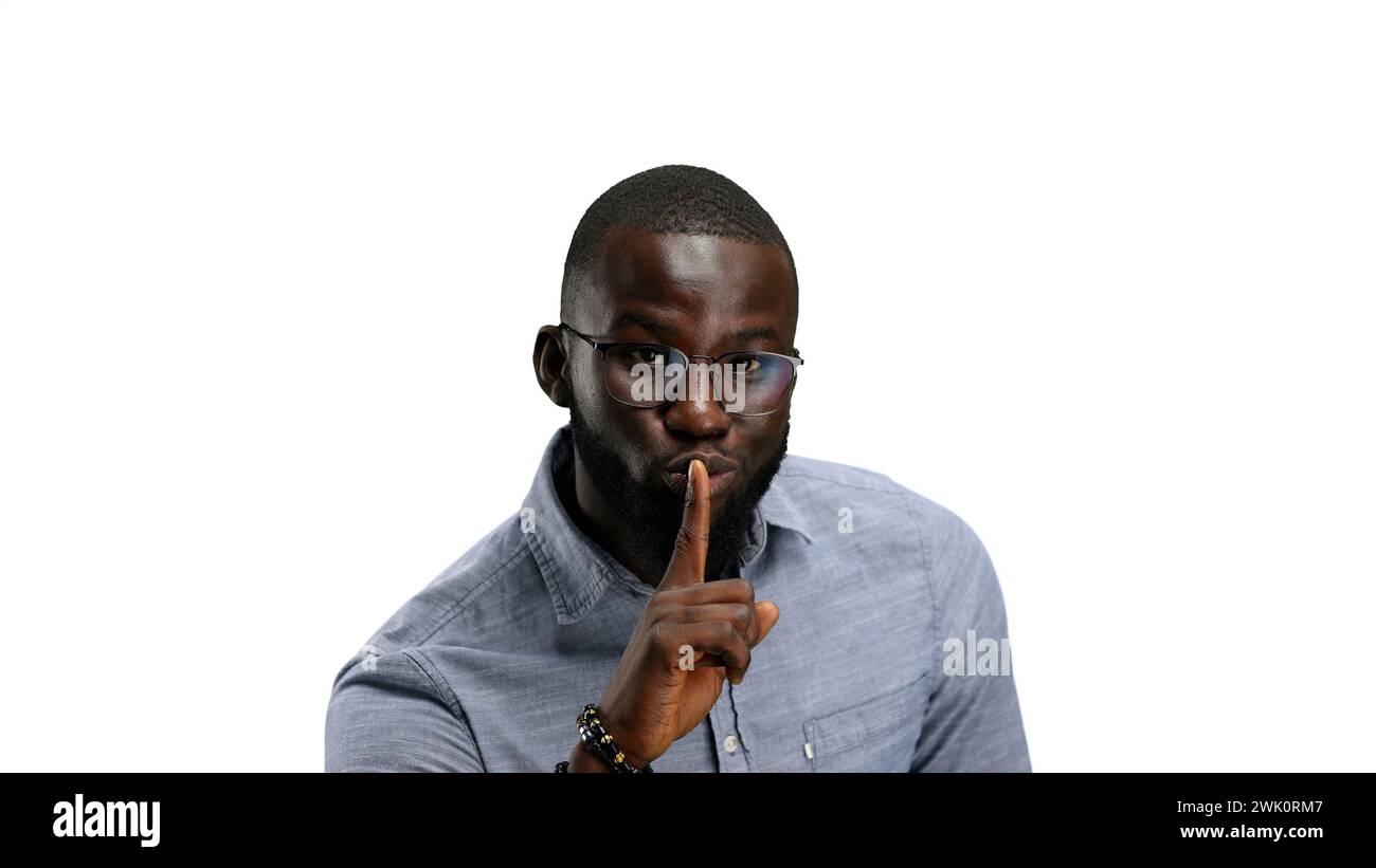 A man, close-up, on a white background, shows a sign of silence Stock ...