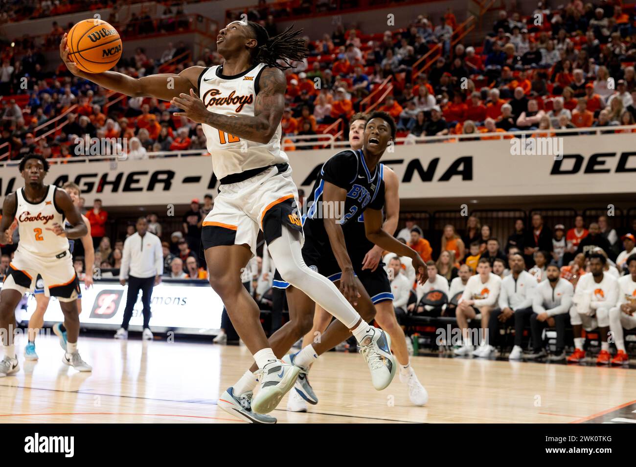 Oklahoma State guard Javon Small (12) shoots around BYU guard Jaxson ...