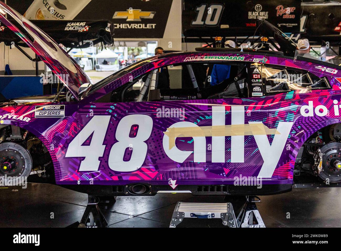 The car of Alex Bowman is worked on after rain forced cancellation of ...