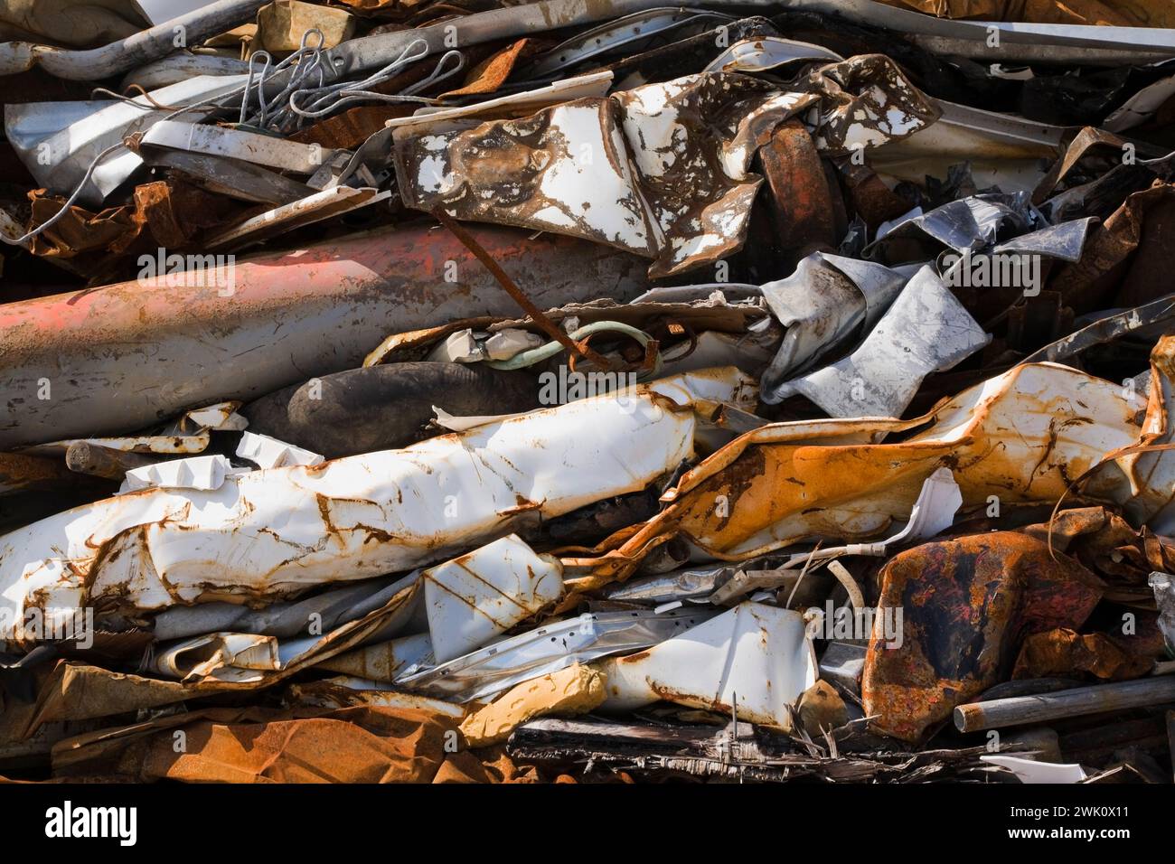 Pile of assorted crushed and compacted rusted pipes and storage tanks ...