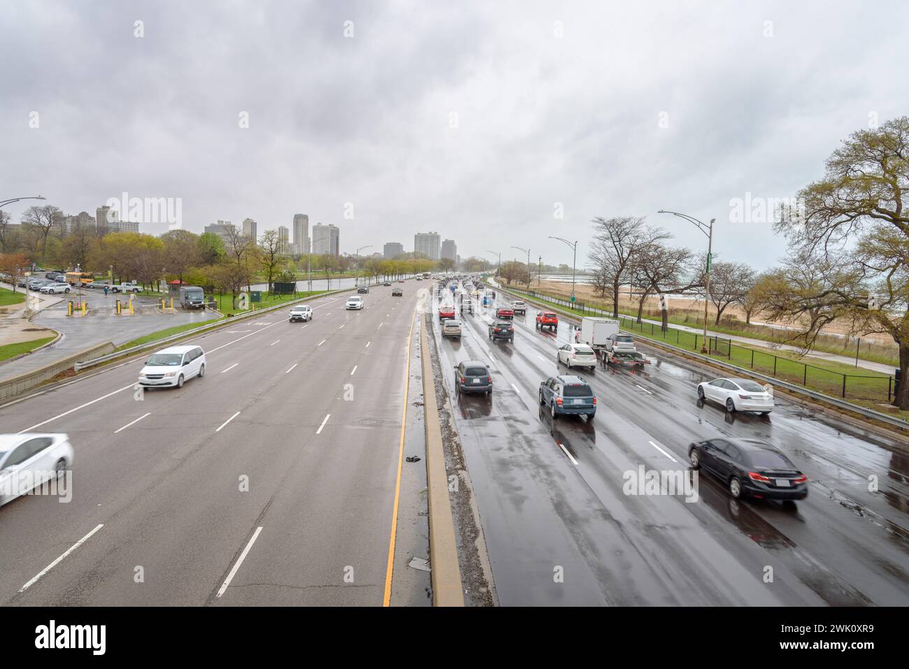 Fast flowing traffic on a four-lane urban highway on a raining spring ...