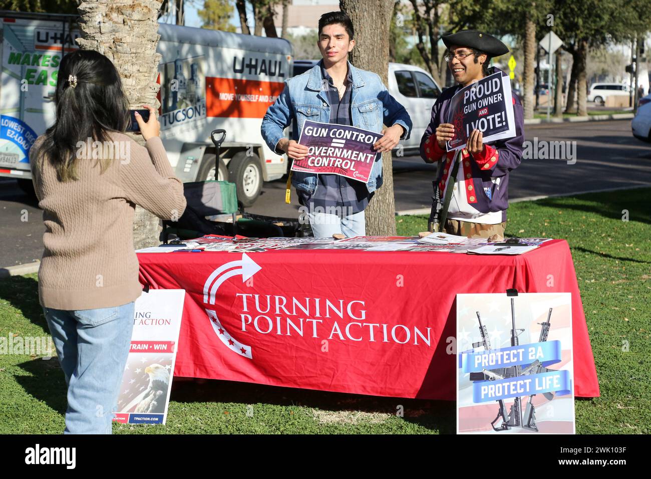 A woman snaps a picture at the Turning Point USA booth at ArizonaÕs ...