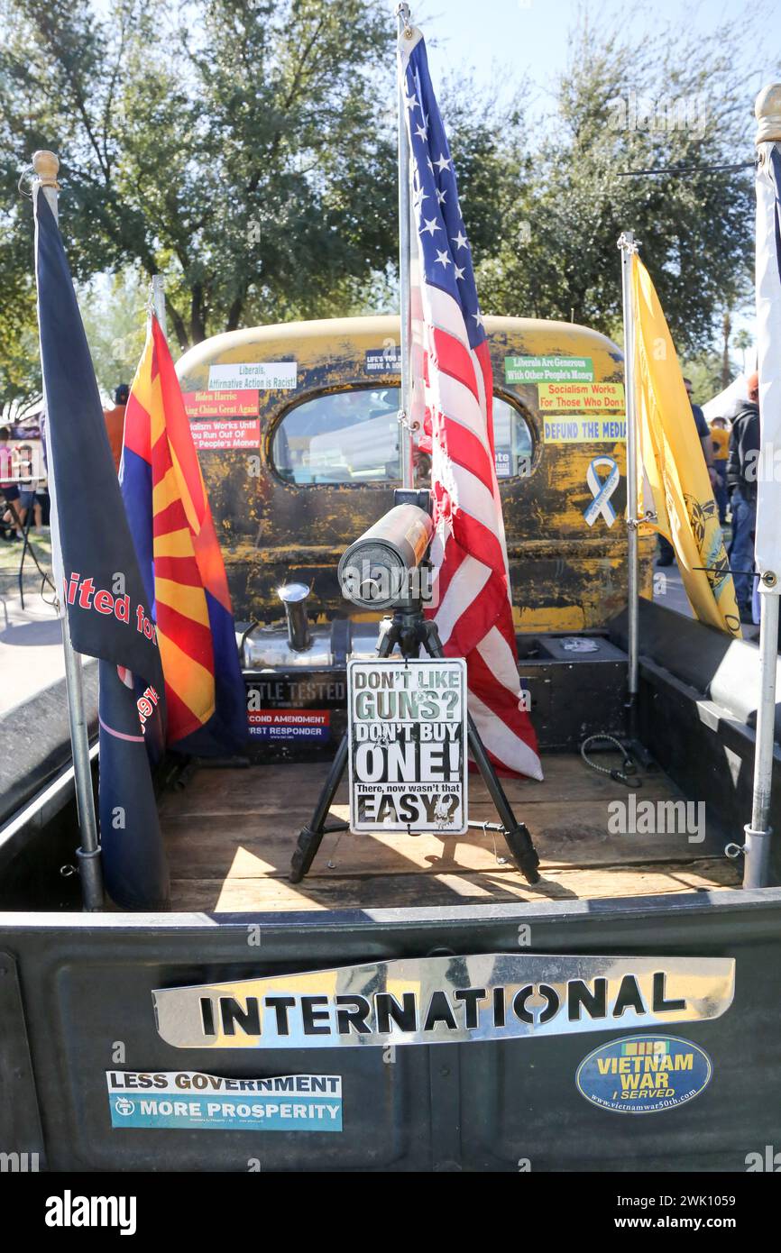 An old truck with many bumper stickers and slogans is parked at the ...