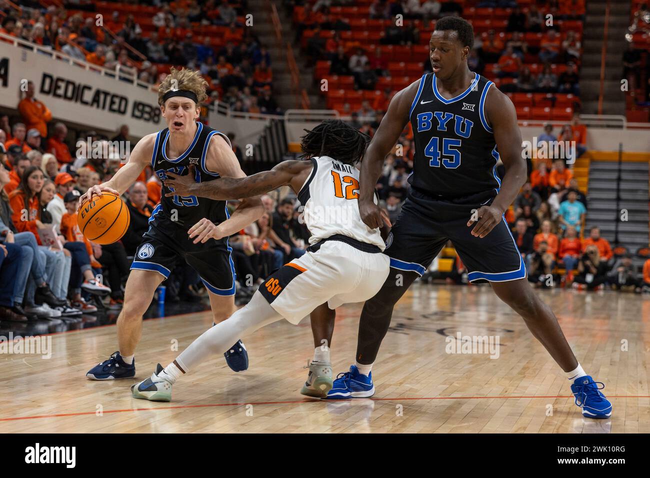 BYU guard Richie Saunders (15) drives past Oklahoma State guard Javon ...