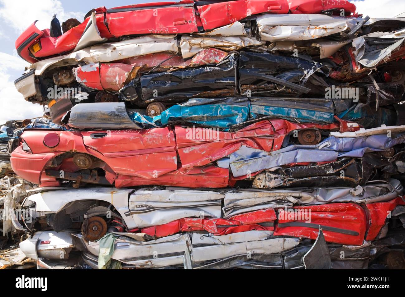Pile of crushed and stacked automobiles at scrap metal recycling ...
