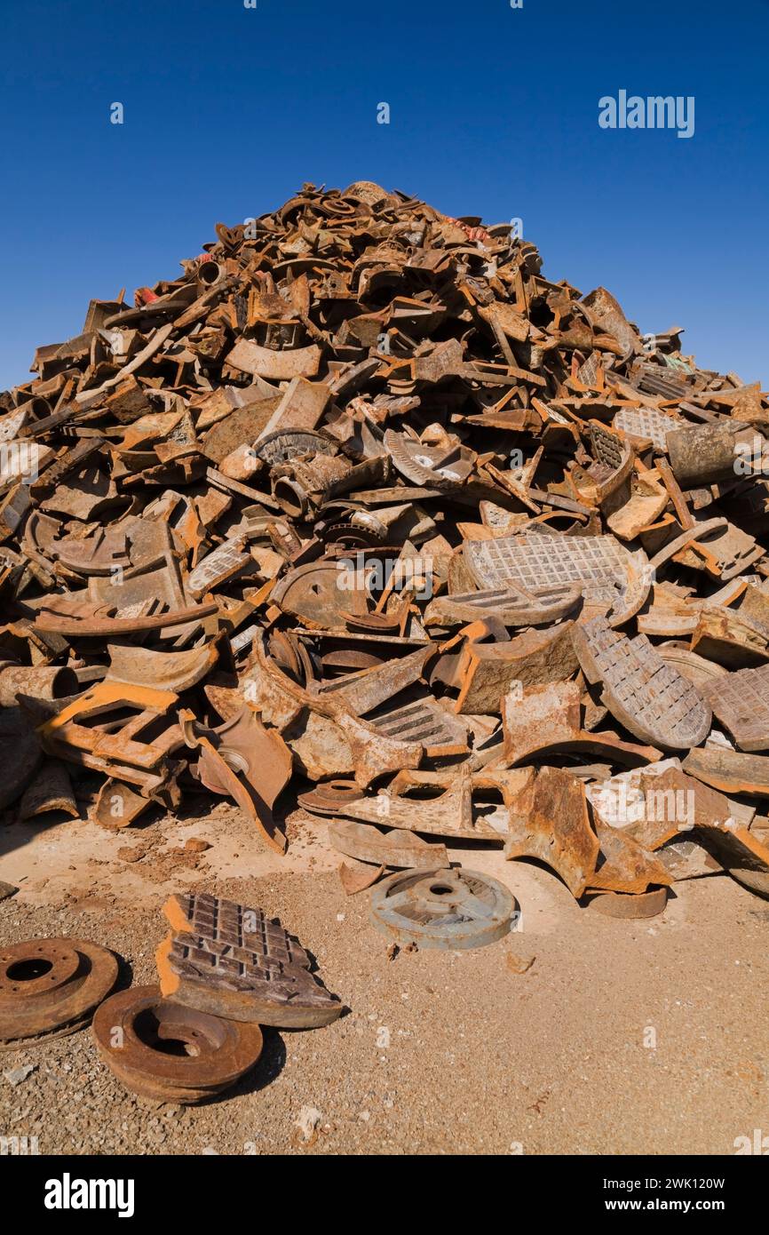 Pile of assorted rusted manhole and sewer covers and other pieces of ...