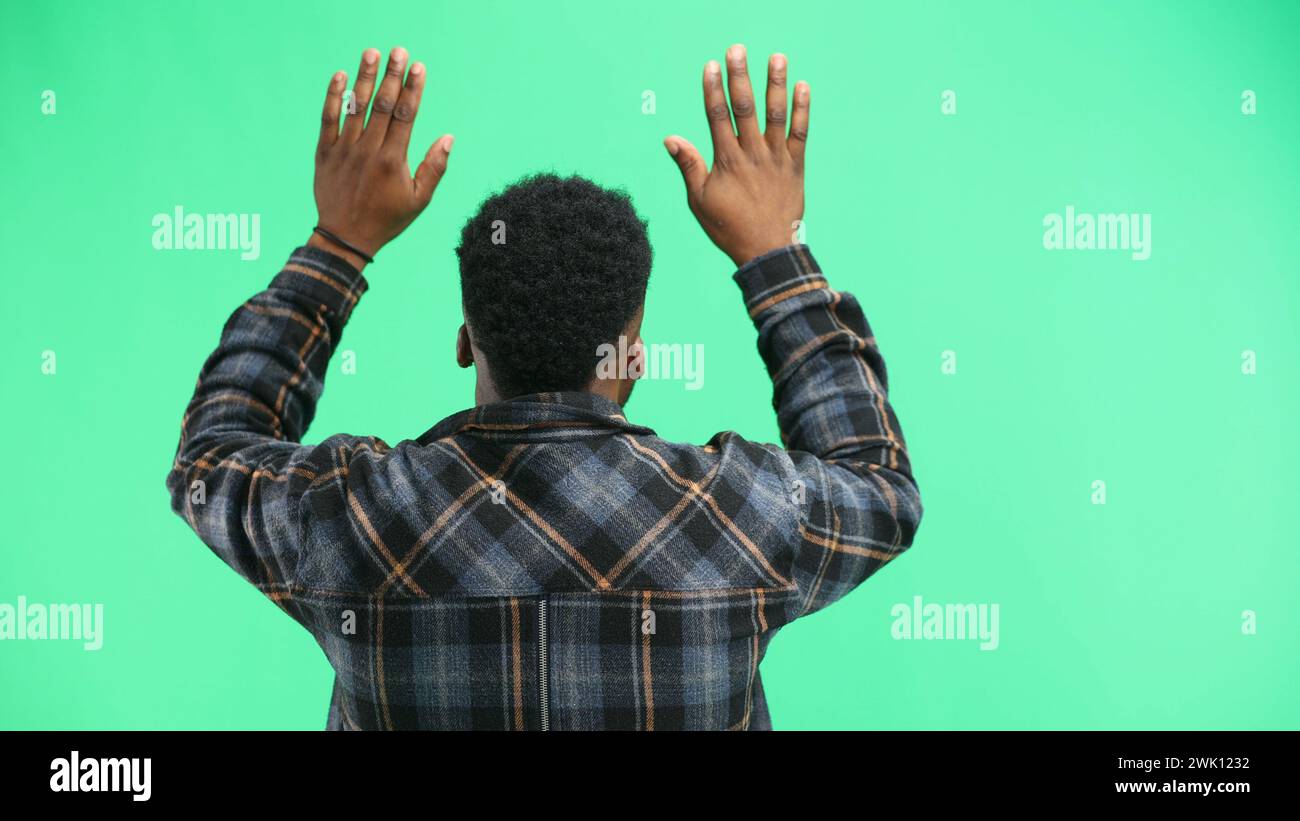 A man, close-up, on a green background, waving his arms Stock Photo - Alamy