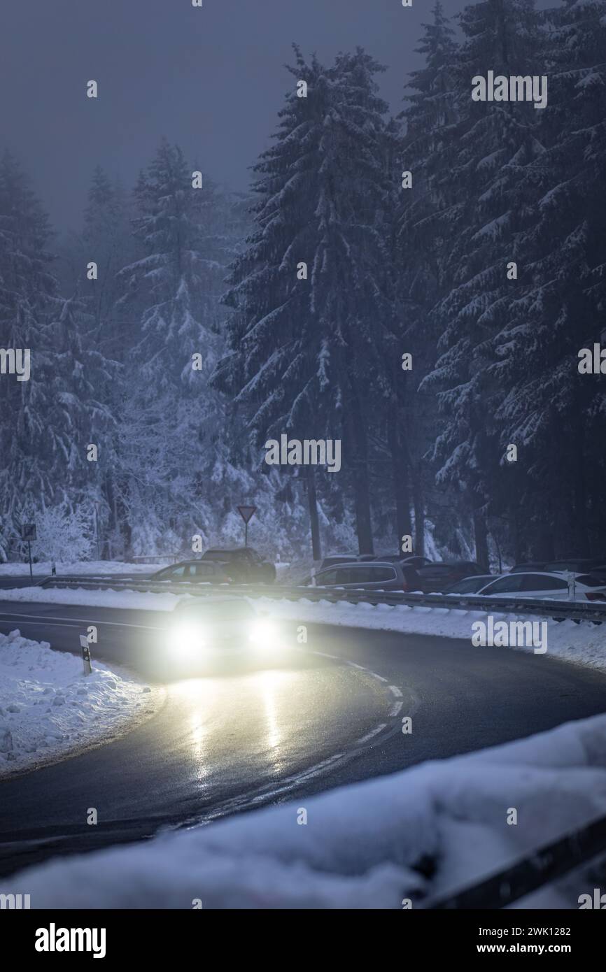 Car on snowy forest road at night Stock Photo - Alamy