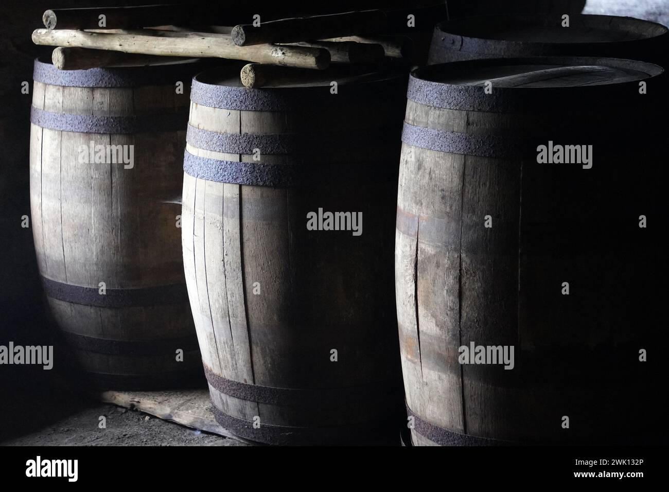 Three oak barrels in partial shadow in a barn Stock Photo - Alamy
