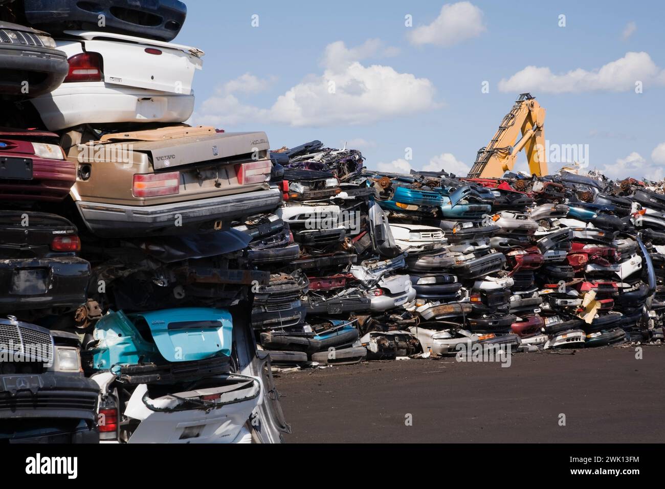 Crushed and stacked discarded automobiles at scrap metal recycling ...