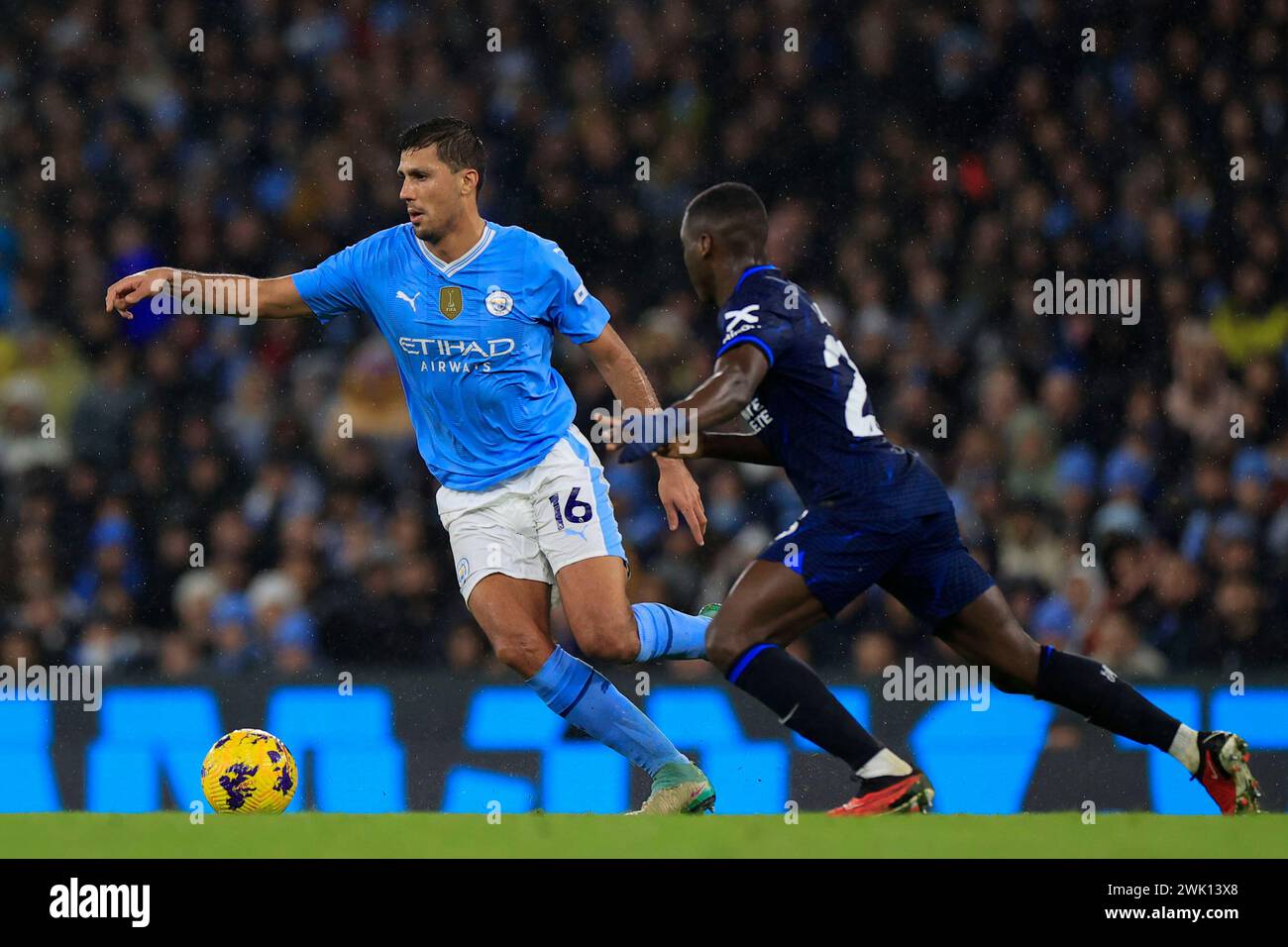 Rodrigo of Manchester City goes past Moises Caicedo of Chelsea during ...