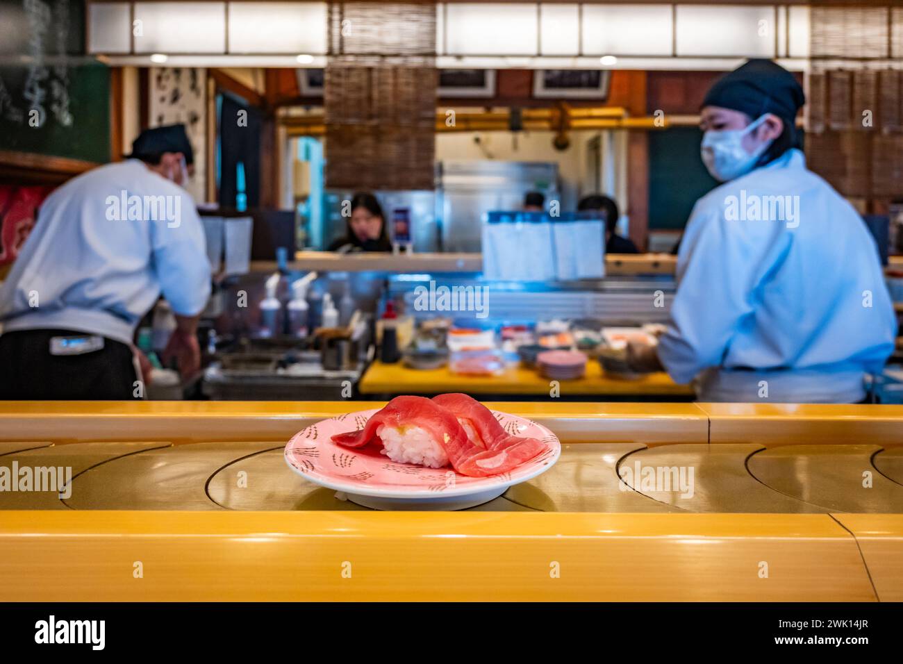 Small plates of food served on a carousel at a local Kaiten-sushi ...