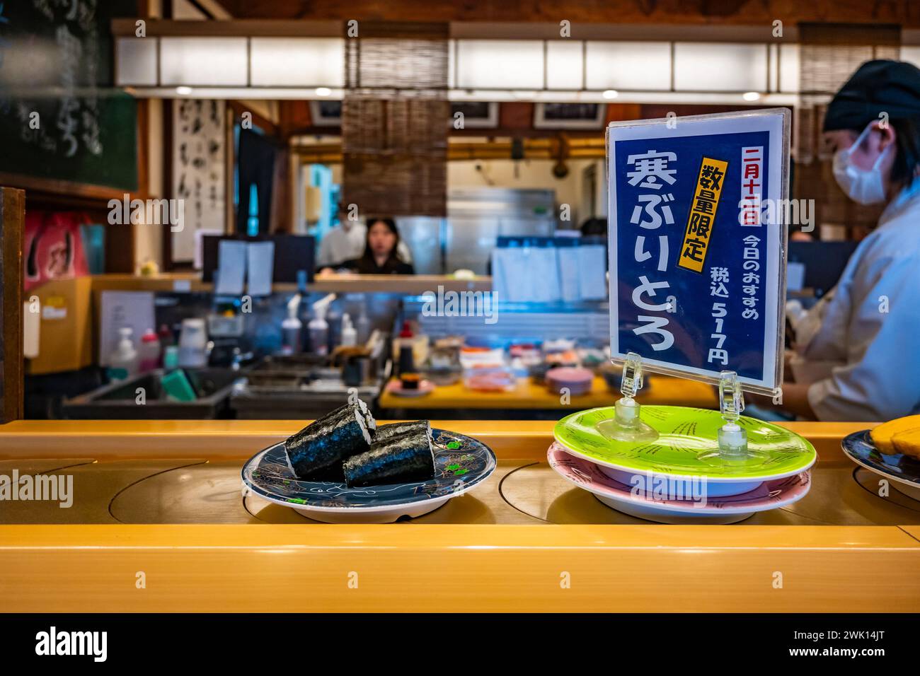 Small plates of food served on a carousel at a local Kaiten-sushi ...