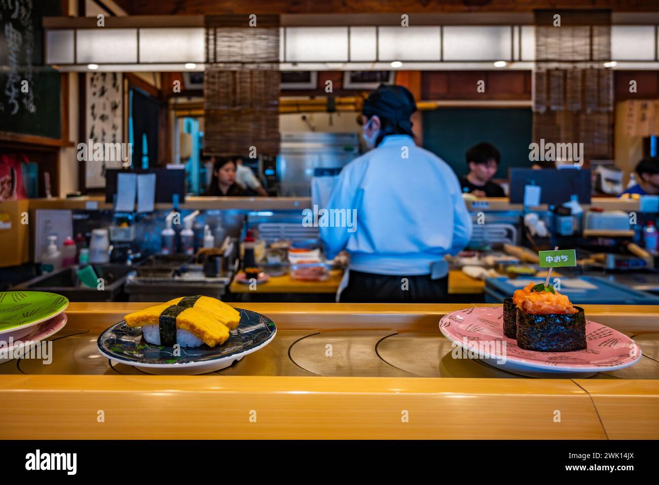 Small plates of food served on a carousel at a local Kaiten-sushi ...