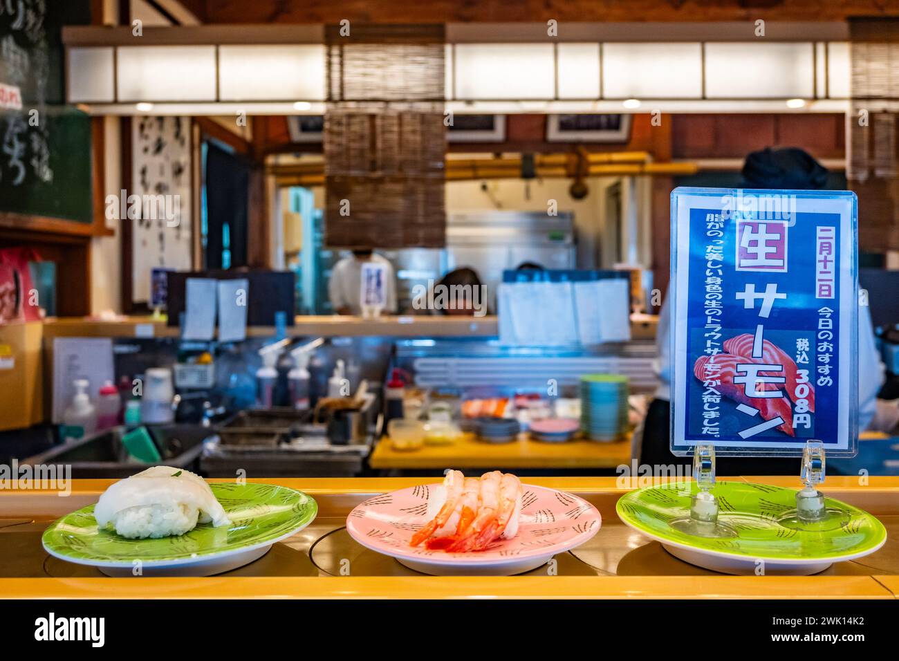 Small plates of food served on a carousel at a local Kaiten-sushi ...