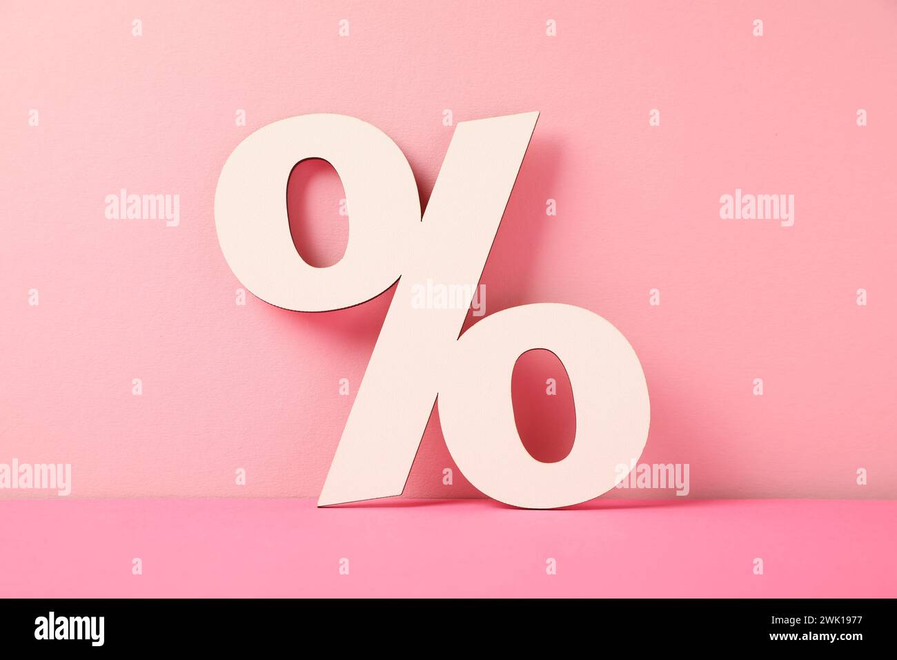 White wooden percent sign on pink background Stock Photo - Alamy