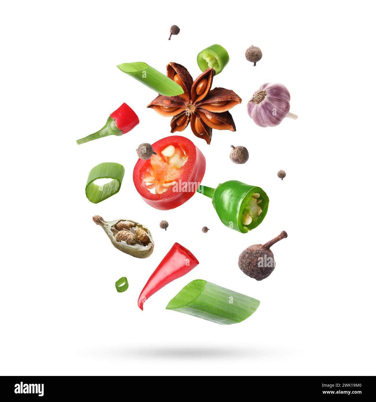 Different aromatic spices falling on white background Stock Photo - Alamy