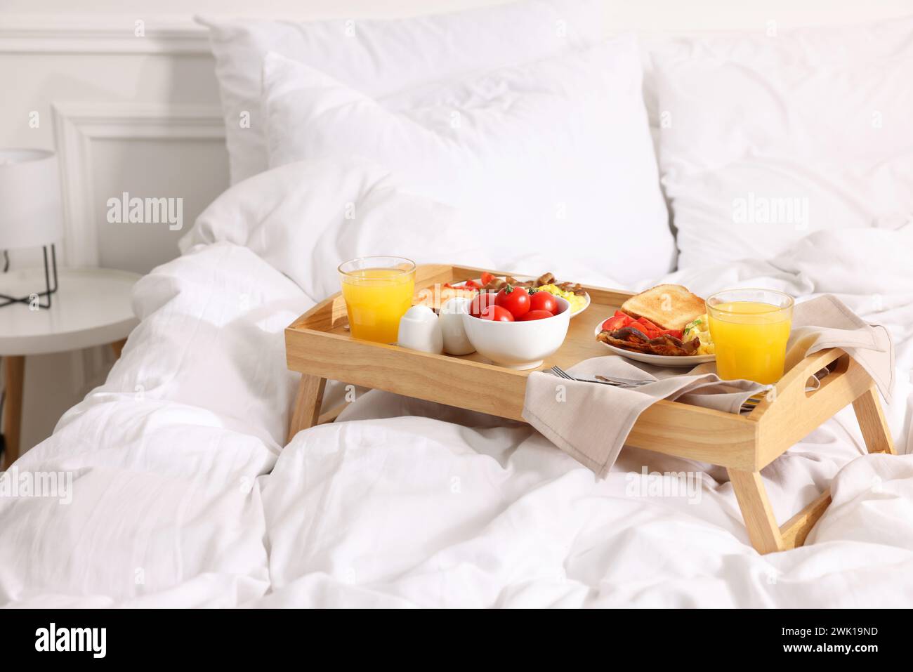 Good morning. Tray with tasty breakfast on bed at home Stock Photo - Alamy