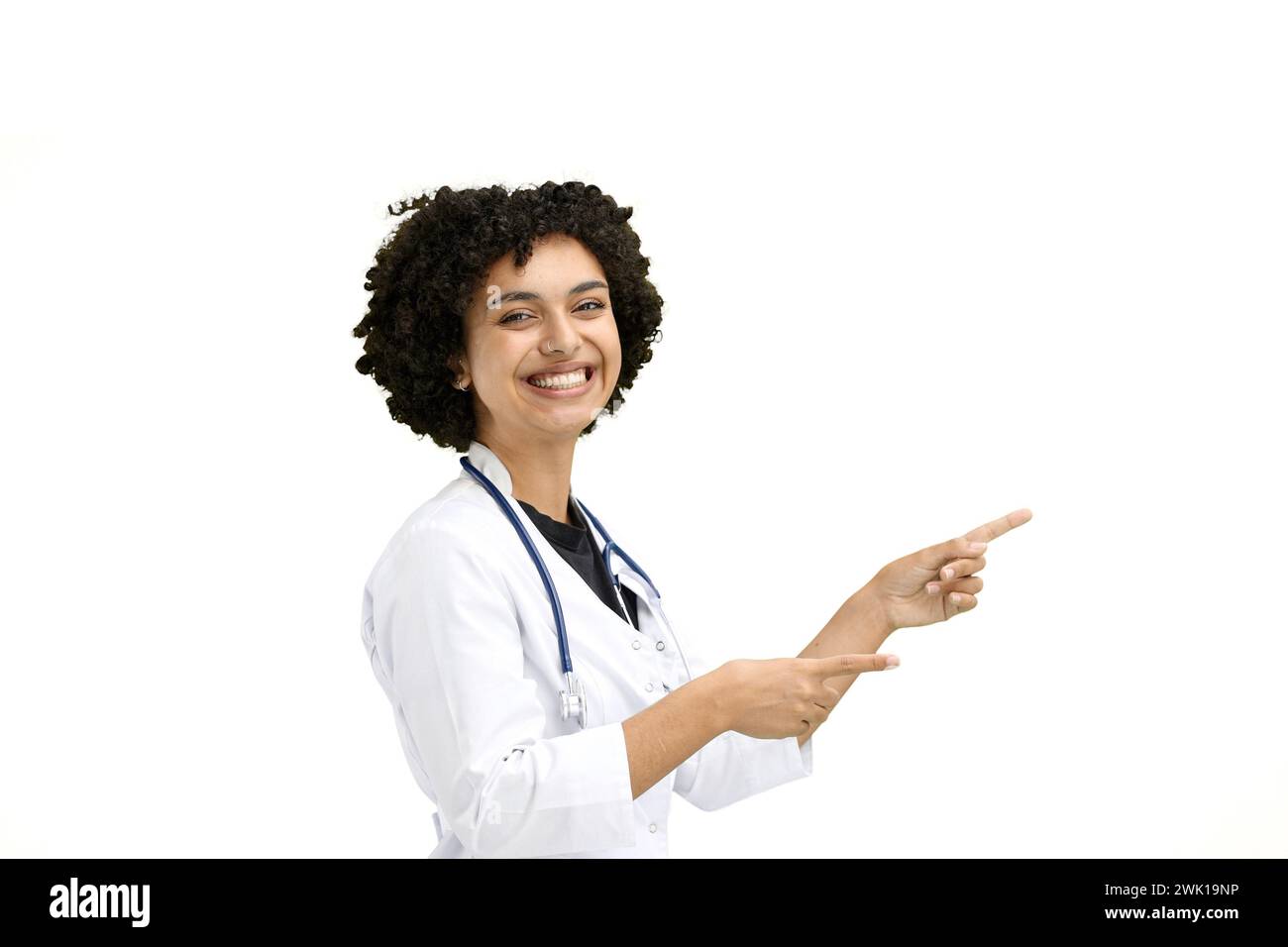 Female doctor, close-up, on a white background, pointing to the side ...