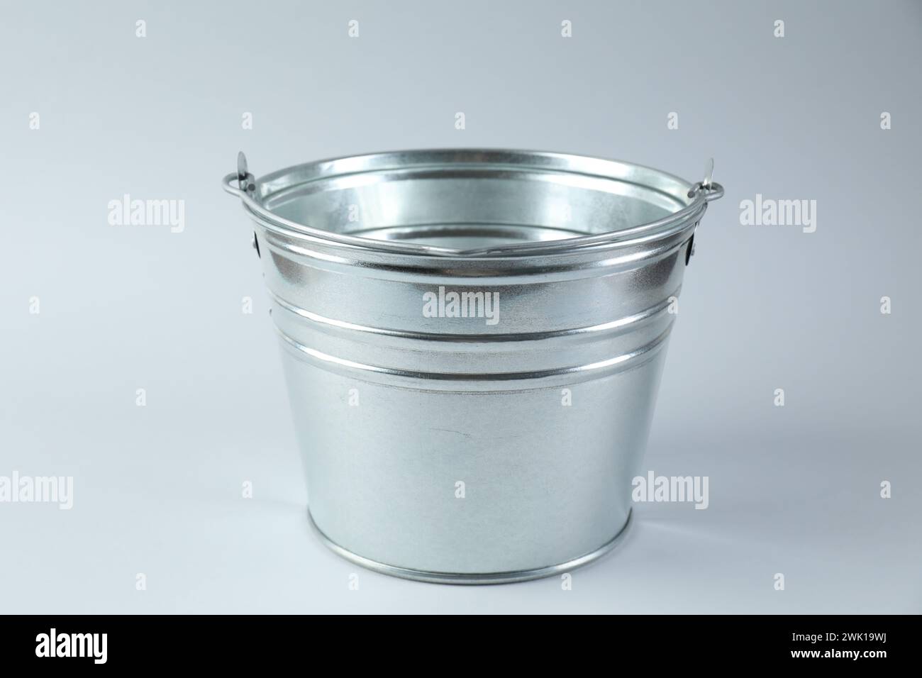 One shiny metal bucket on white background Stock Photo - Alamy