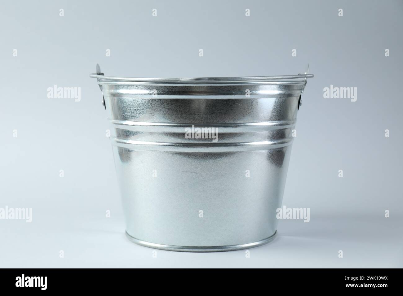 One shiny metal bucket on white background Stock Photo - Alamy
