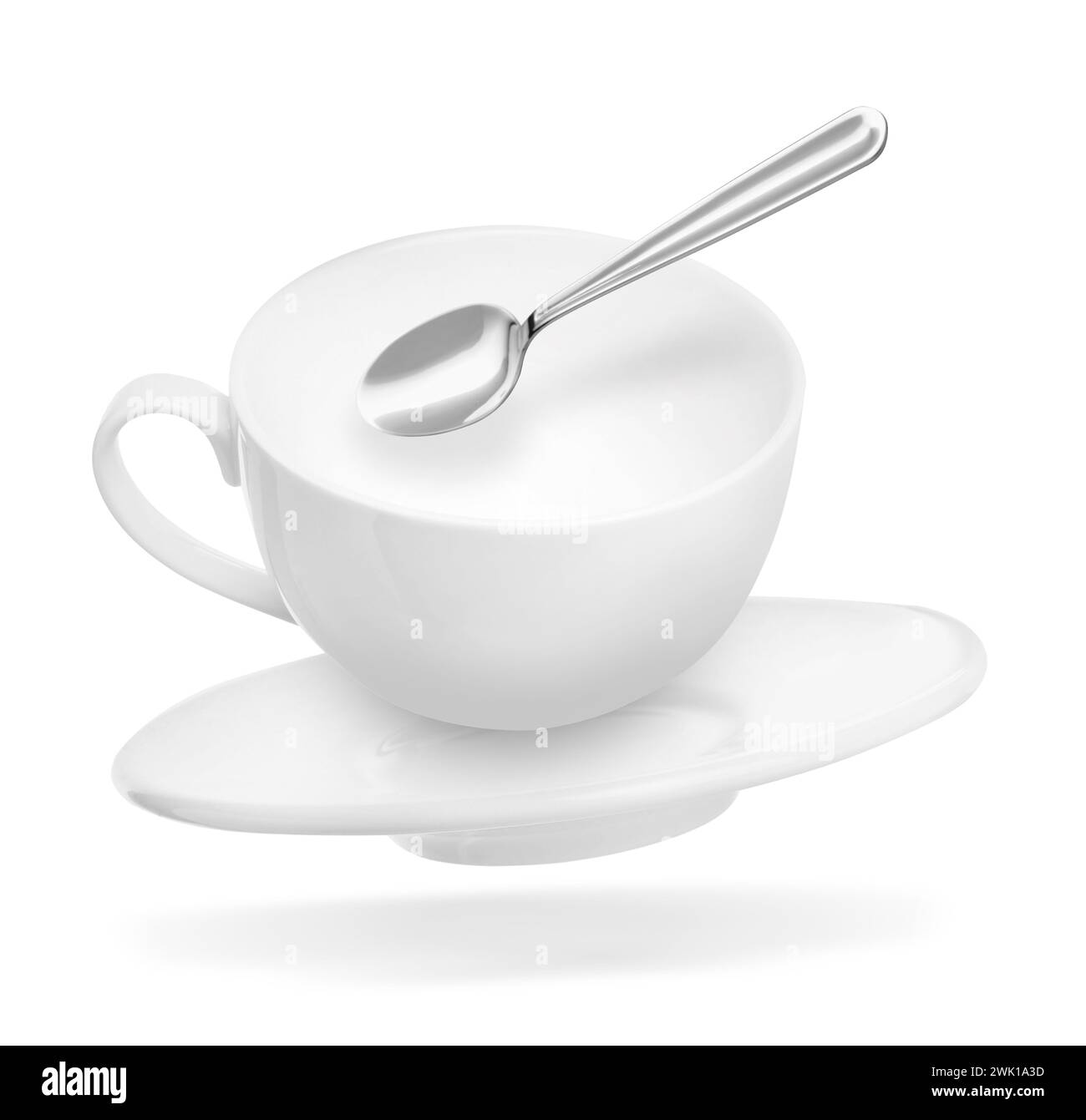 Spoon, cup and saucer falling on white background Stock Photo - Alamy