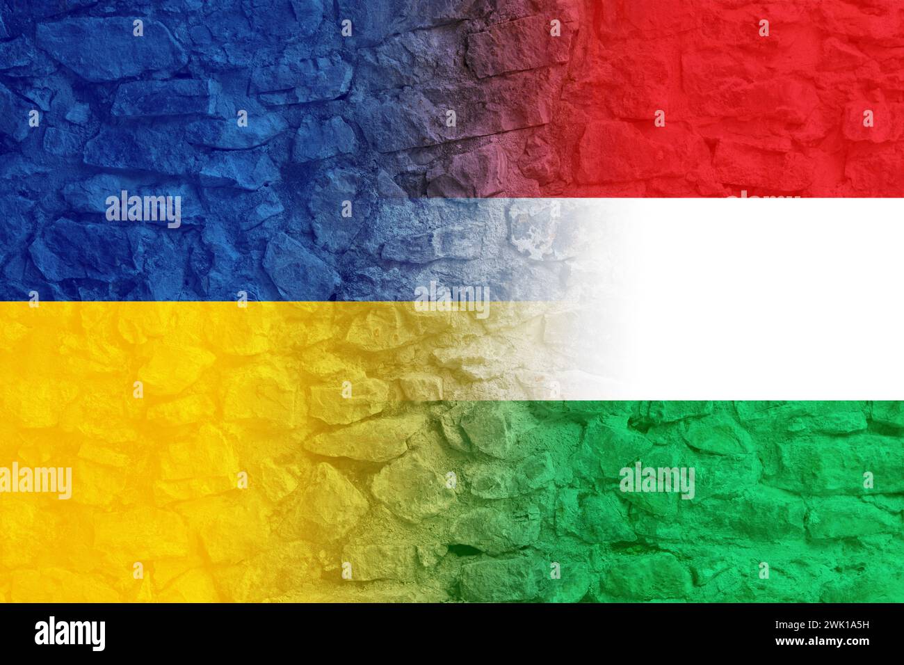 Flags of Ukraine and Hungary on stone wall. International diplomatic ...
