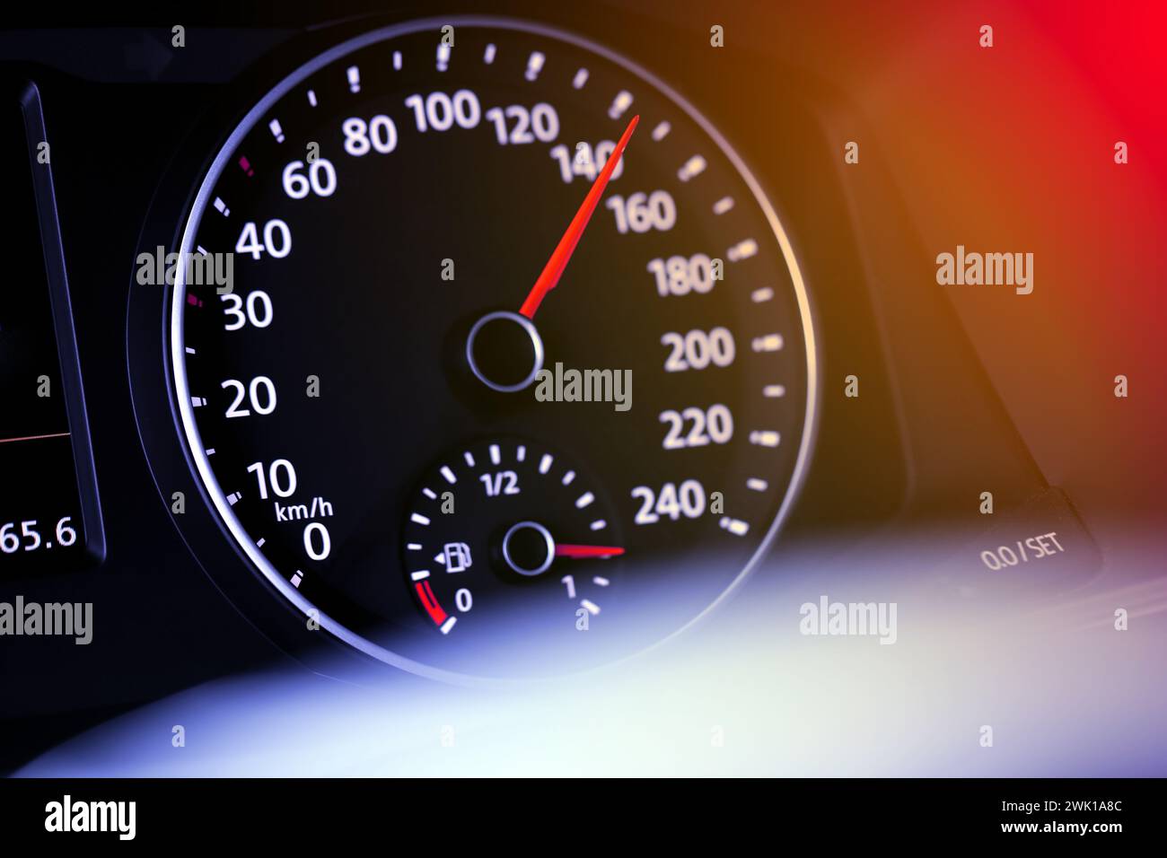 Speedometer on car dashboard under red and orange light, closeup Stock ...