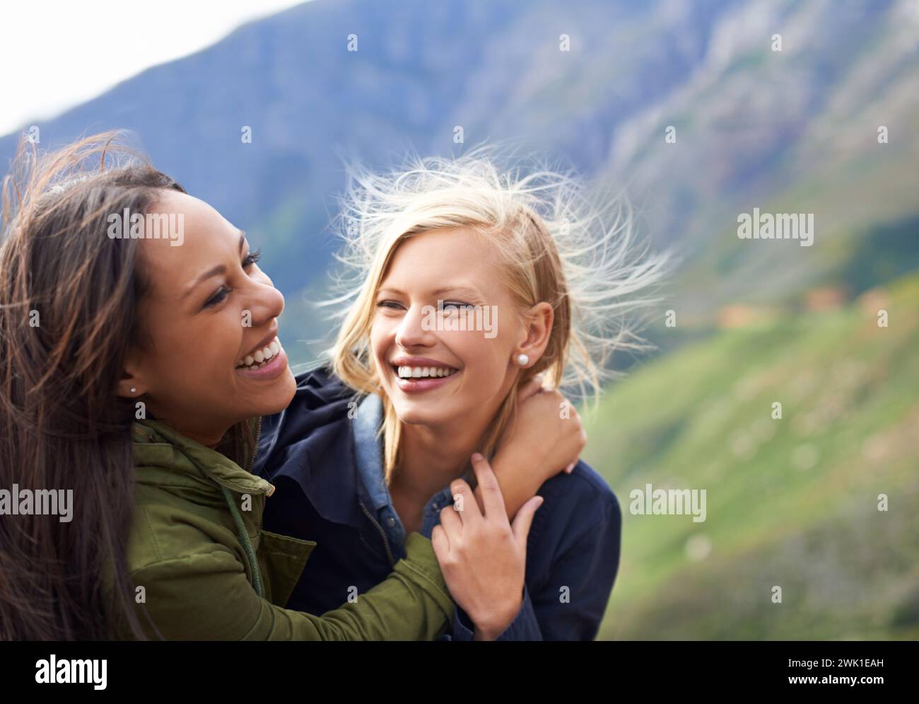 Happy woman, friends and laughing with hug in nature for funny joke ...