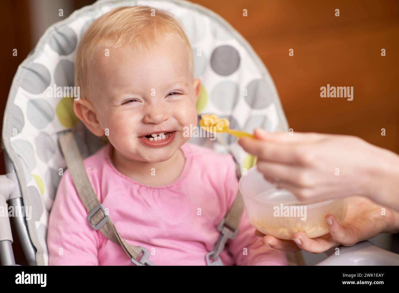 Happy, baby and laughing from feeding in high chair at home in the ...