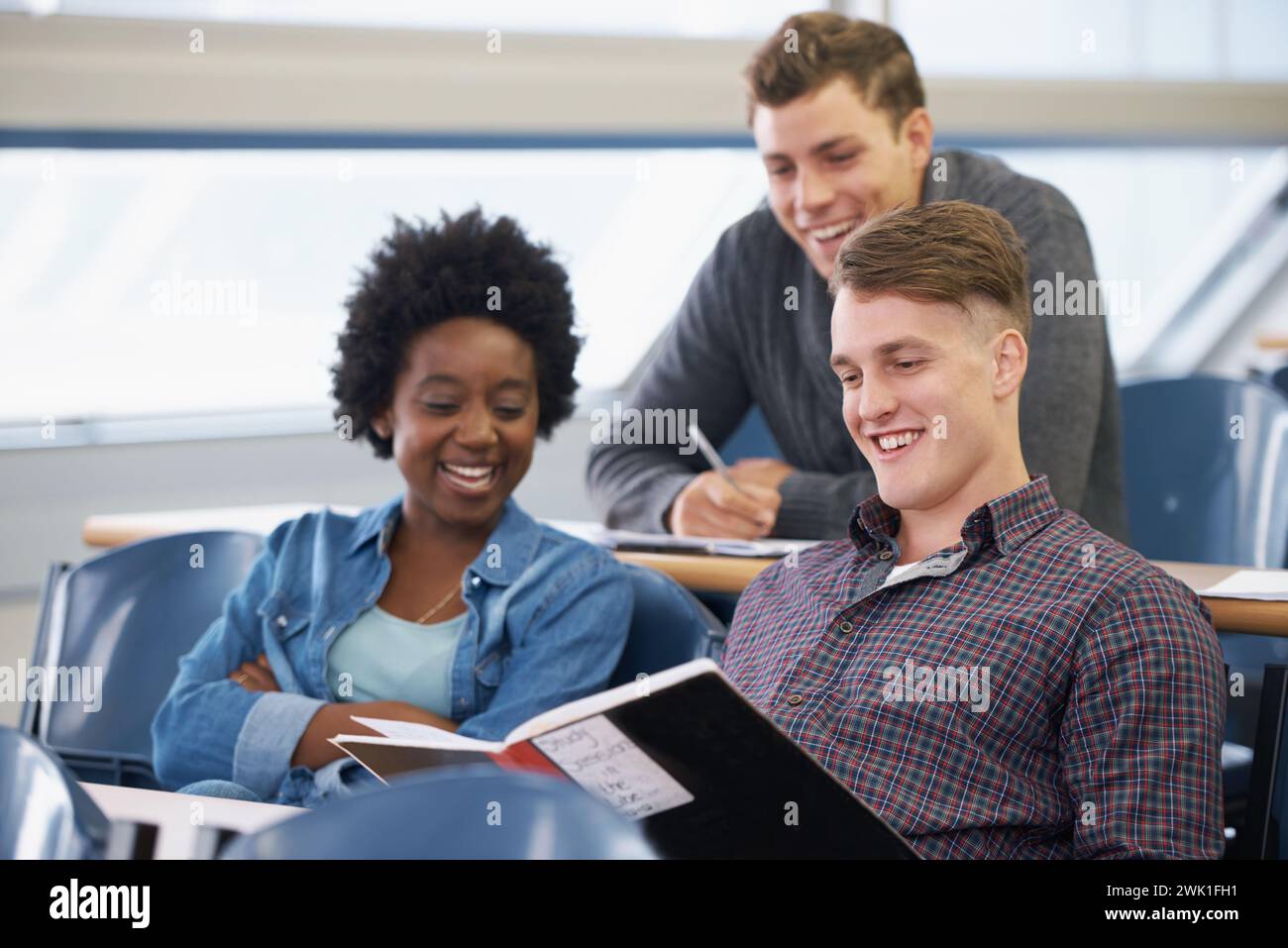 Student, studying and friends in a classroom with learning, education ...