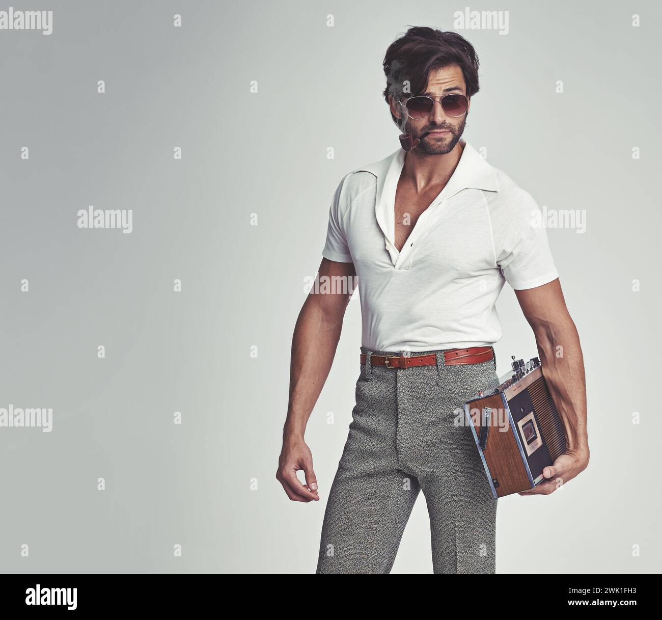 Man, fashion and retro with radio in studio, grey background and smart ...