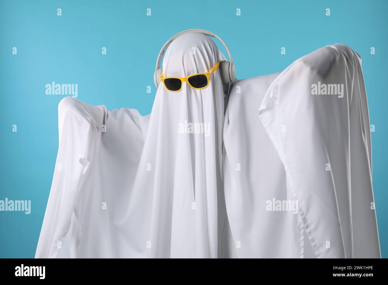 Stylish ghost. Person covered with white sheet in sunglasses and ...
