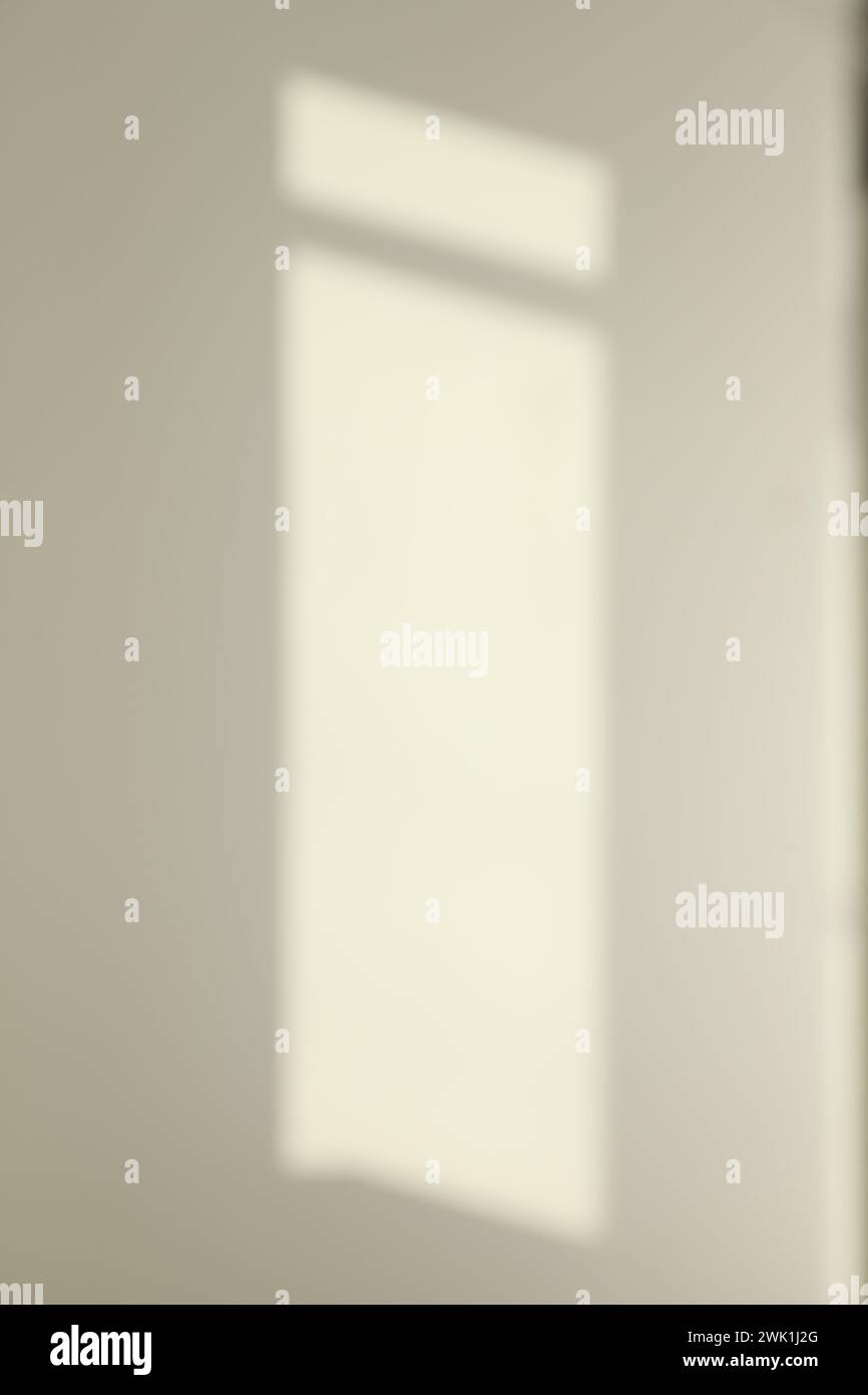 Blurred view of light and shadows from window on wall indoors Stock ...