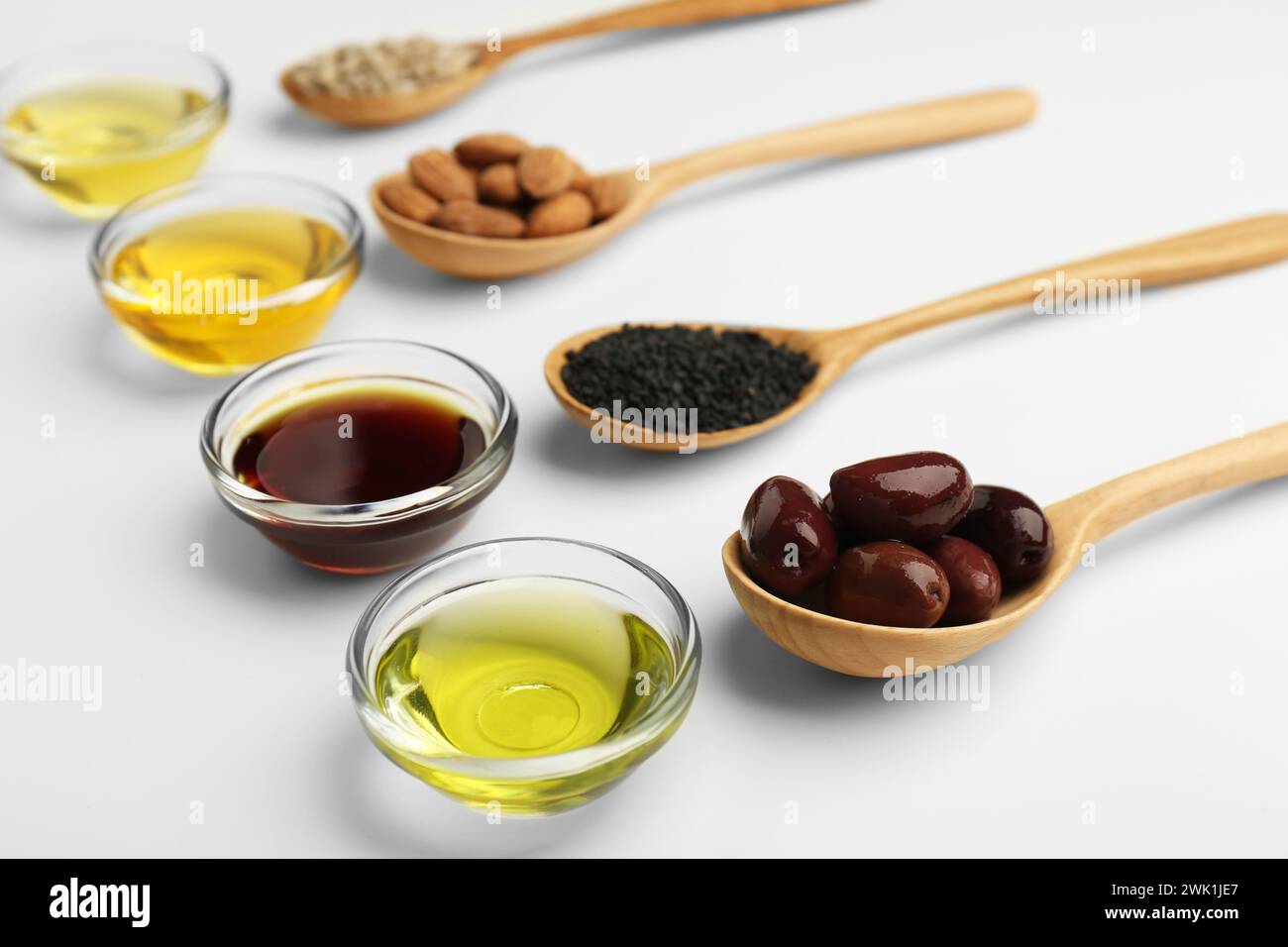 Vegetable fats. Different cooking oils in bowls and spoons with ...
