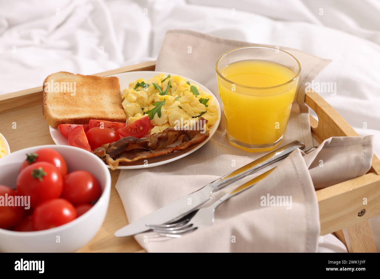 Good morning. Tray with tasty breakfast on bed Stock Photo - Alamy